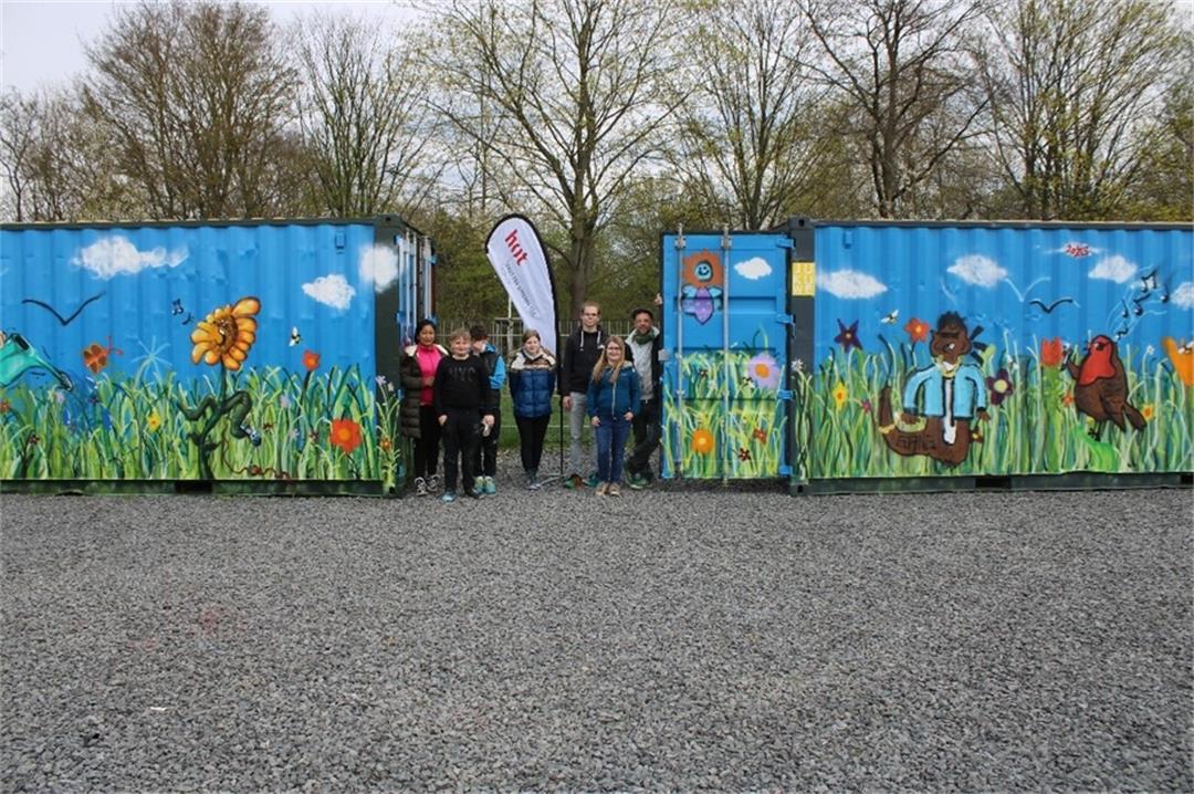 Jugendliche lassen alte Container in neuem Graffiti Look erstrahlen